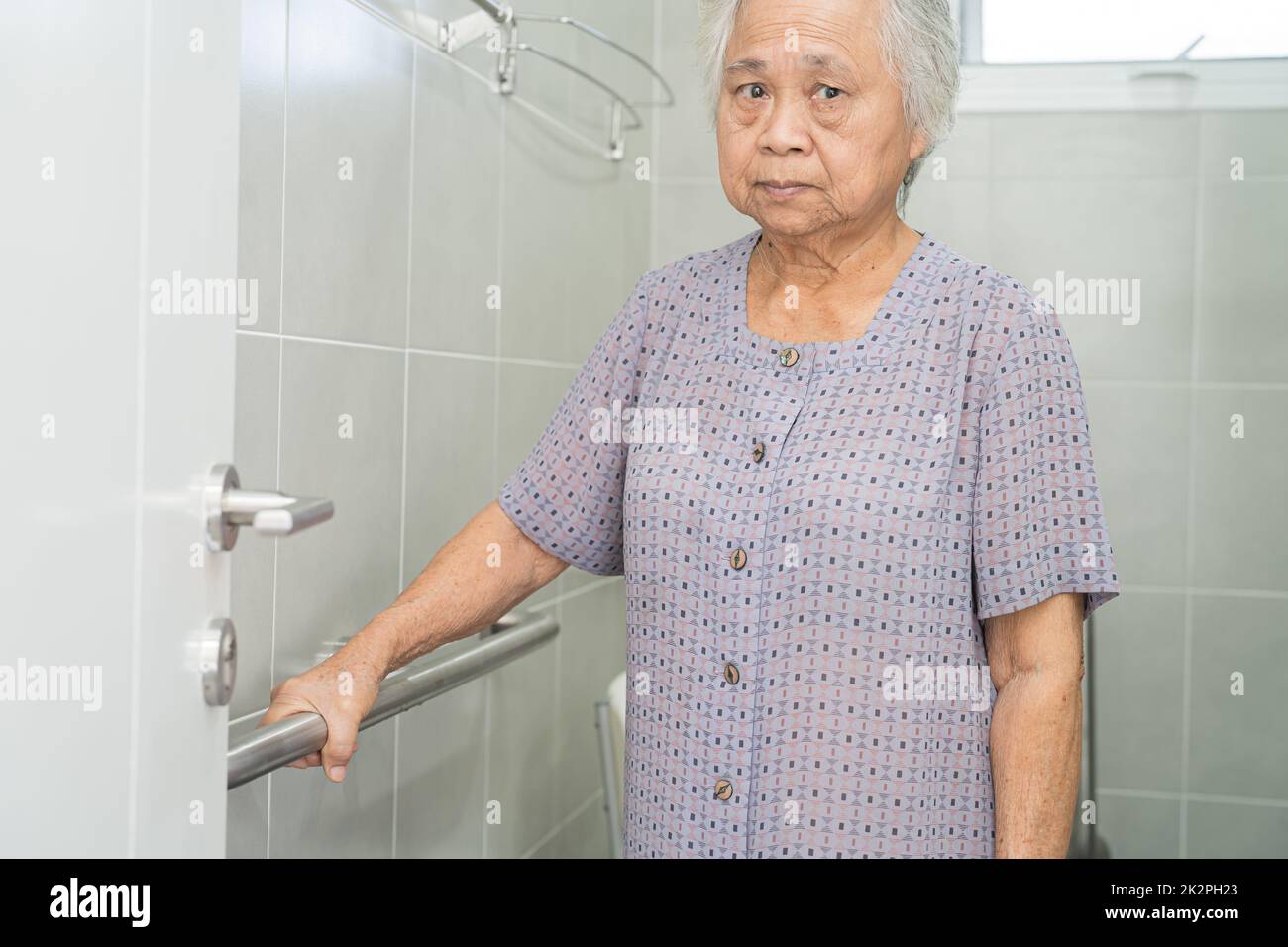 Asian senior or elderly old lady woman patient use toilet bathroom ...