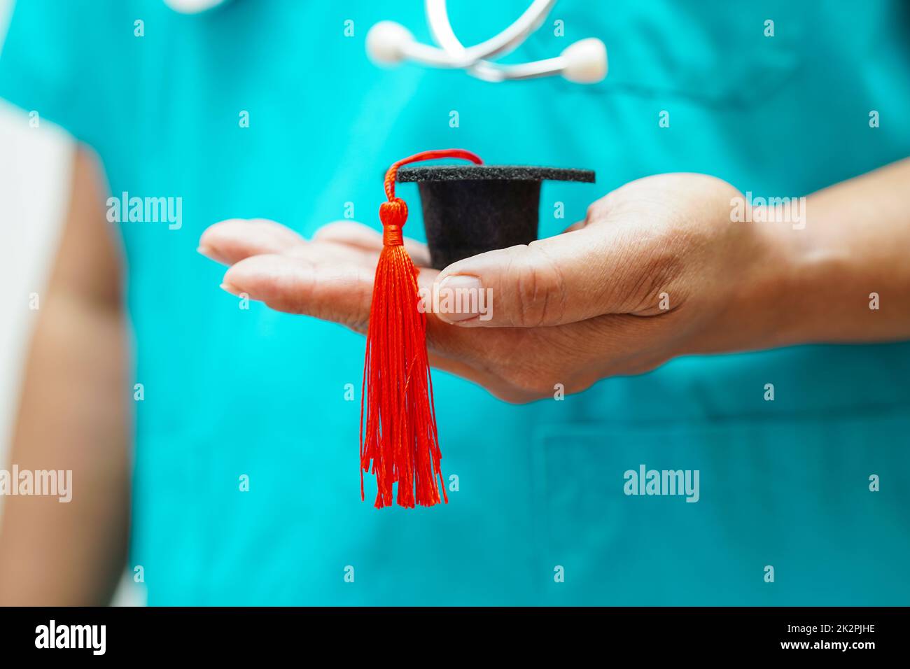 Asian woman doctor holding graduation hat in hospital, Medical ...