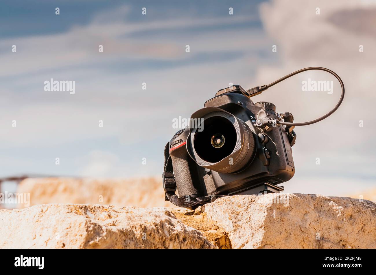 Professional digital camera on top of the stone block. Close up photo ...