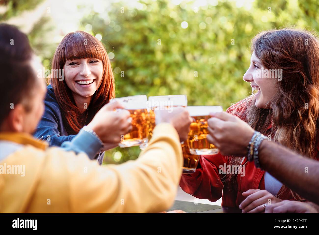 Group of friends toasting with a glass of beer - Millennials have fun ...