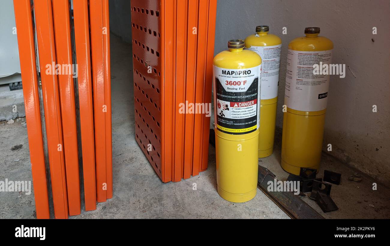 A yellow empty cylinder of finished brazing fuel Stock Photo - Alamy