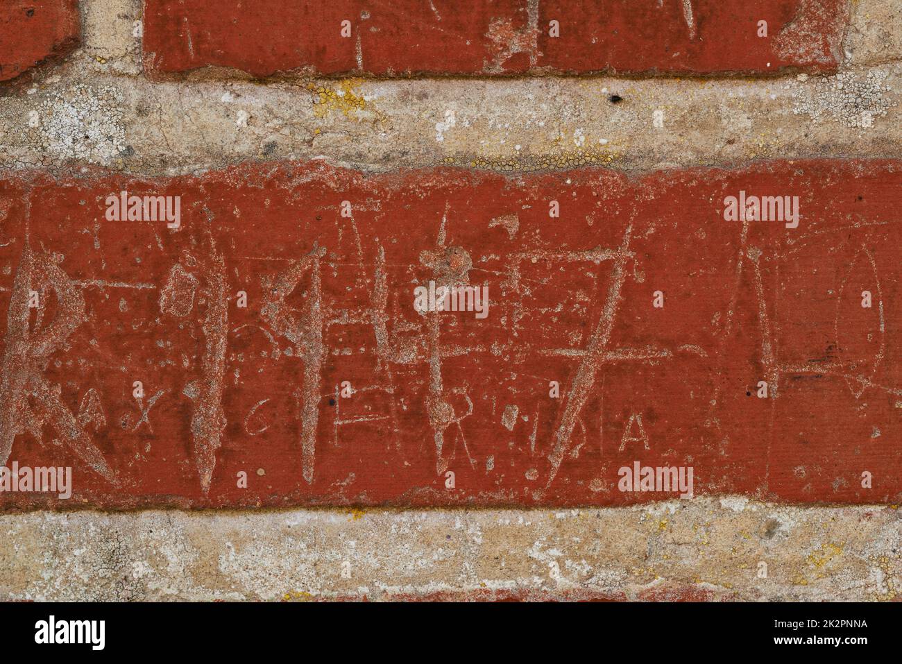 Signature wall. A photo of brick wall of an old school with a lot of ...