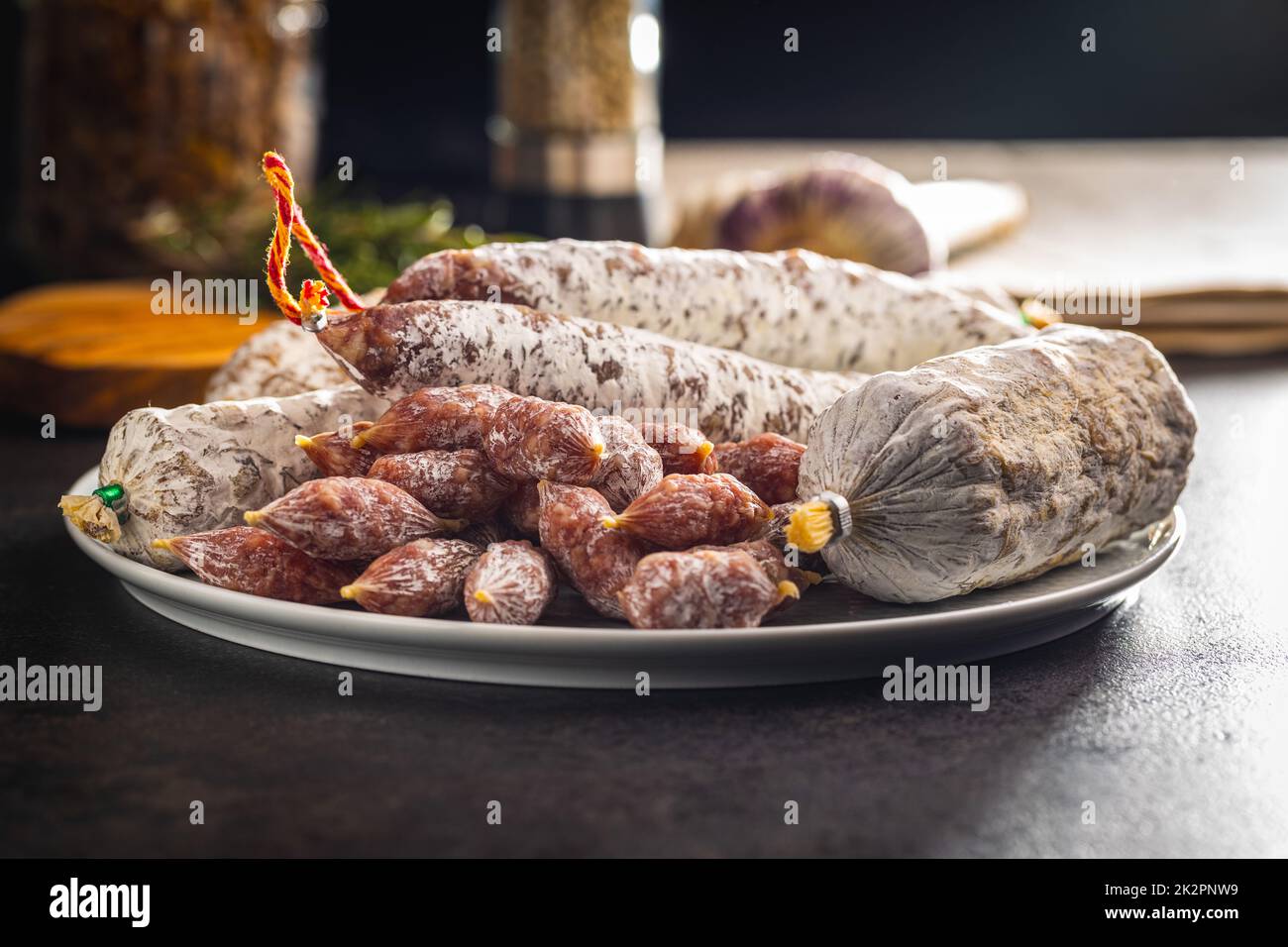 Traditional sausage with white mold. Dried pork salami on plate Stock ...
