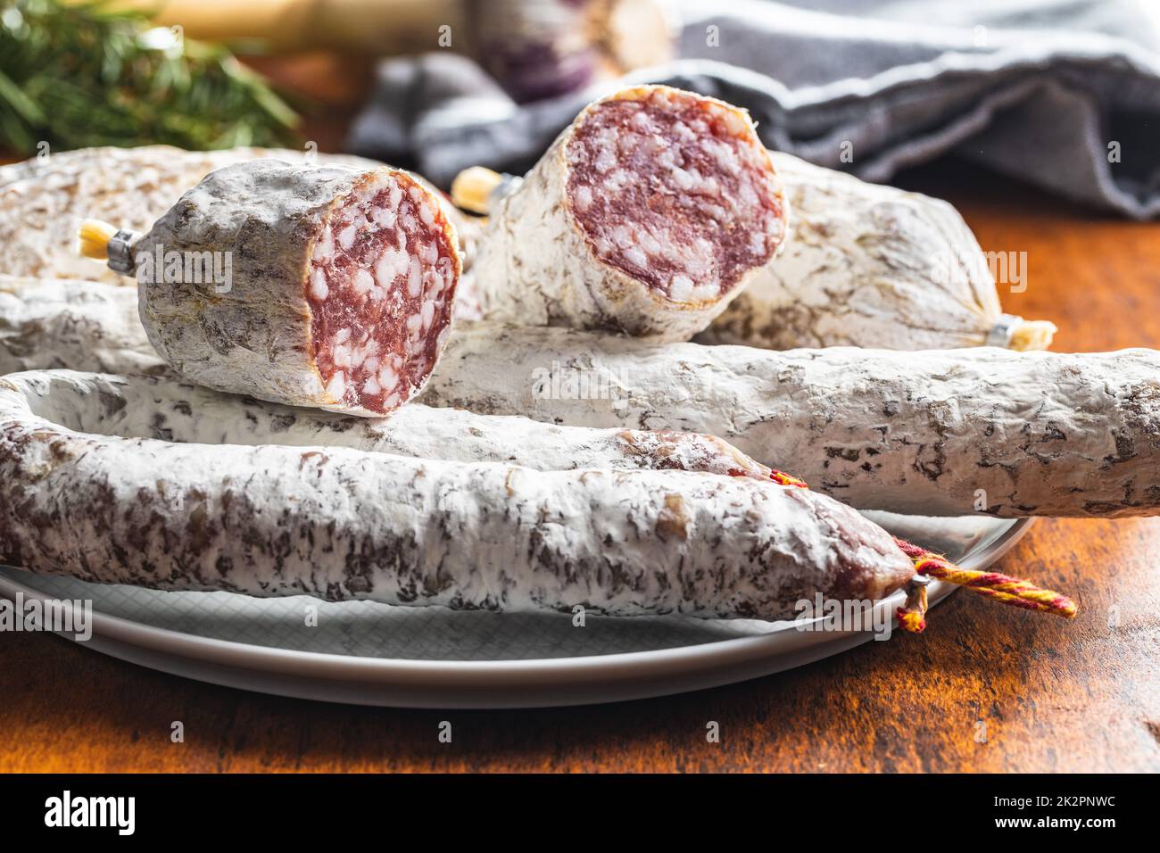 Traditional sausage with white mold. Dried pork salami on plate Stock Photo - Alamy