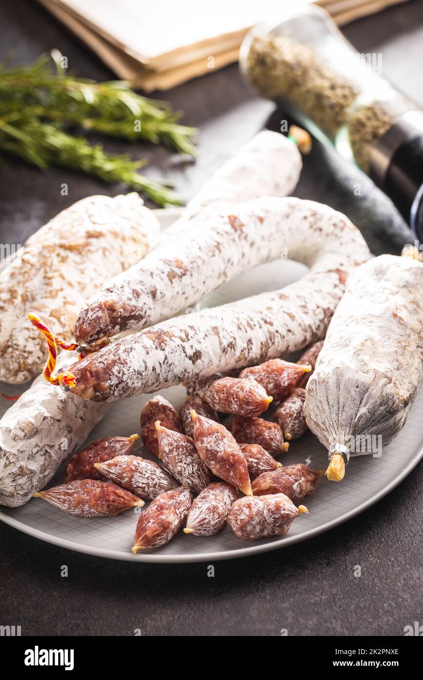 Traditional sausage with white mold. Dried pork salami on plate Stock ...