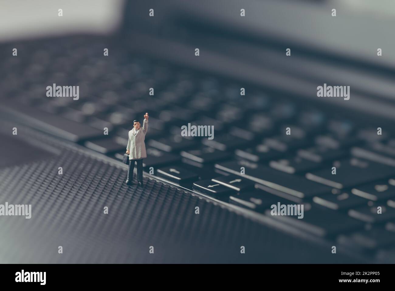 Miniature businessman waving on top of the laptop. Business concept ...