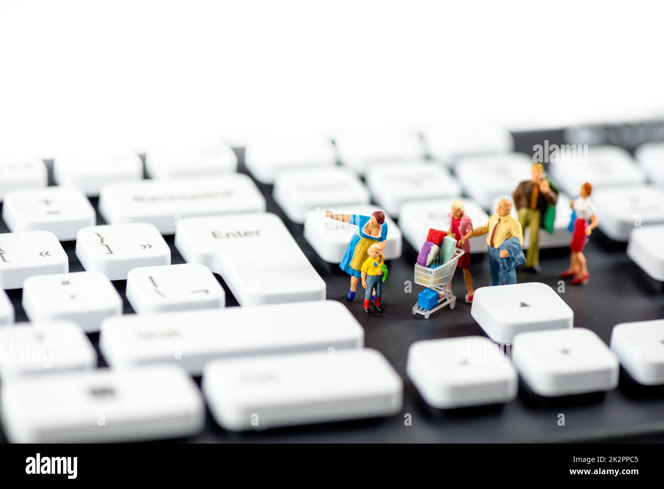 Friendly miniature family looking at computer keyboards. Technology ...