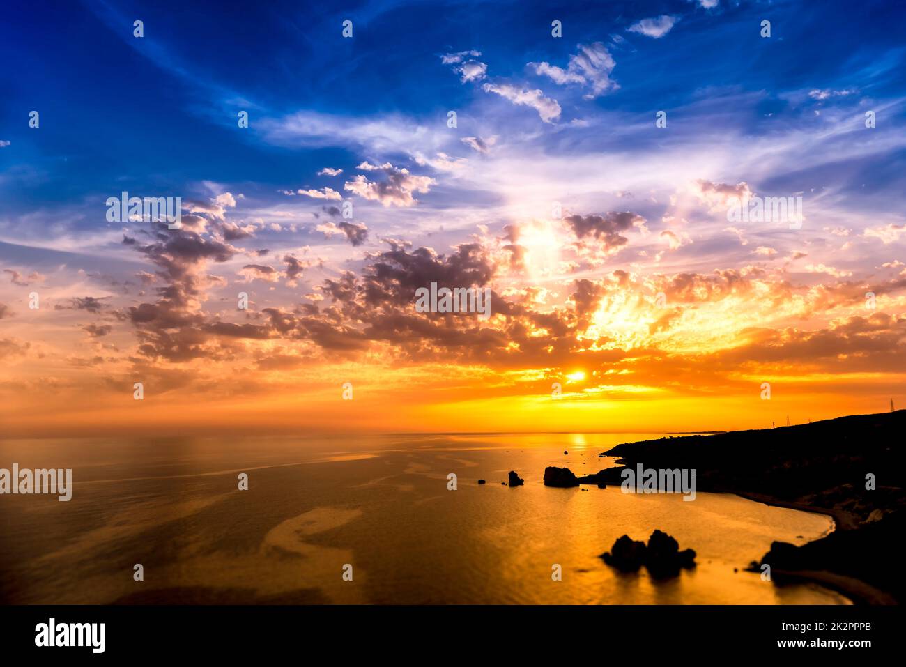 Dramatic sunset over Aphrodite's Rock also known as Rock of the Greek ...