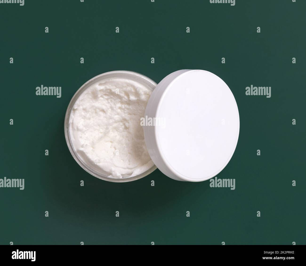 Homemade cream in plastic jar on dark green top view. Brand packaging ...