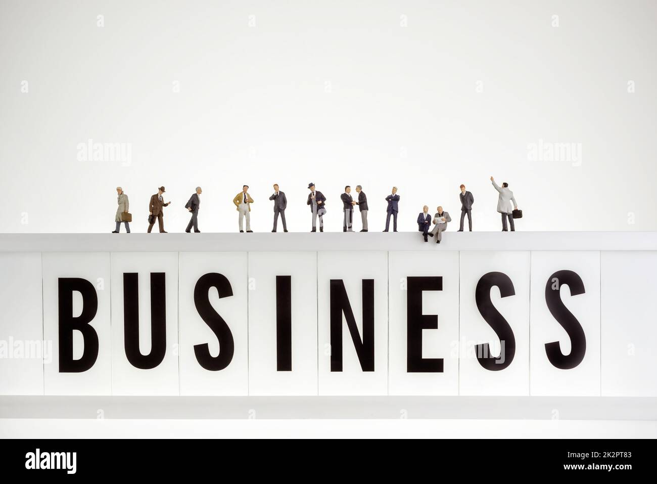 Business word with crowd of miniature business people Stock Photo - Alamy
