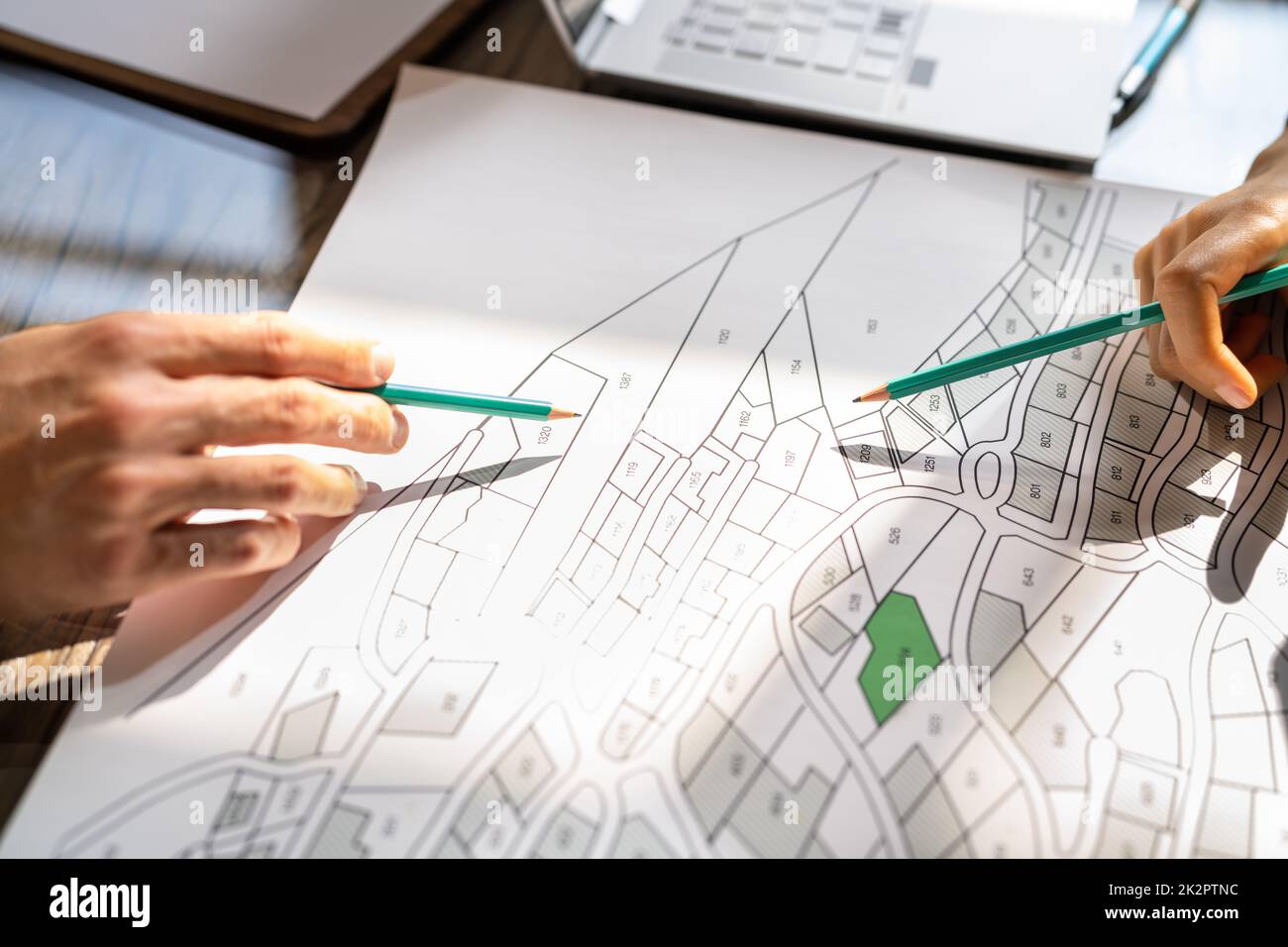 Human Hand Holding Pencil Over Cadastre Map Stock Photo - Alamy