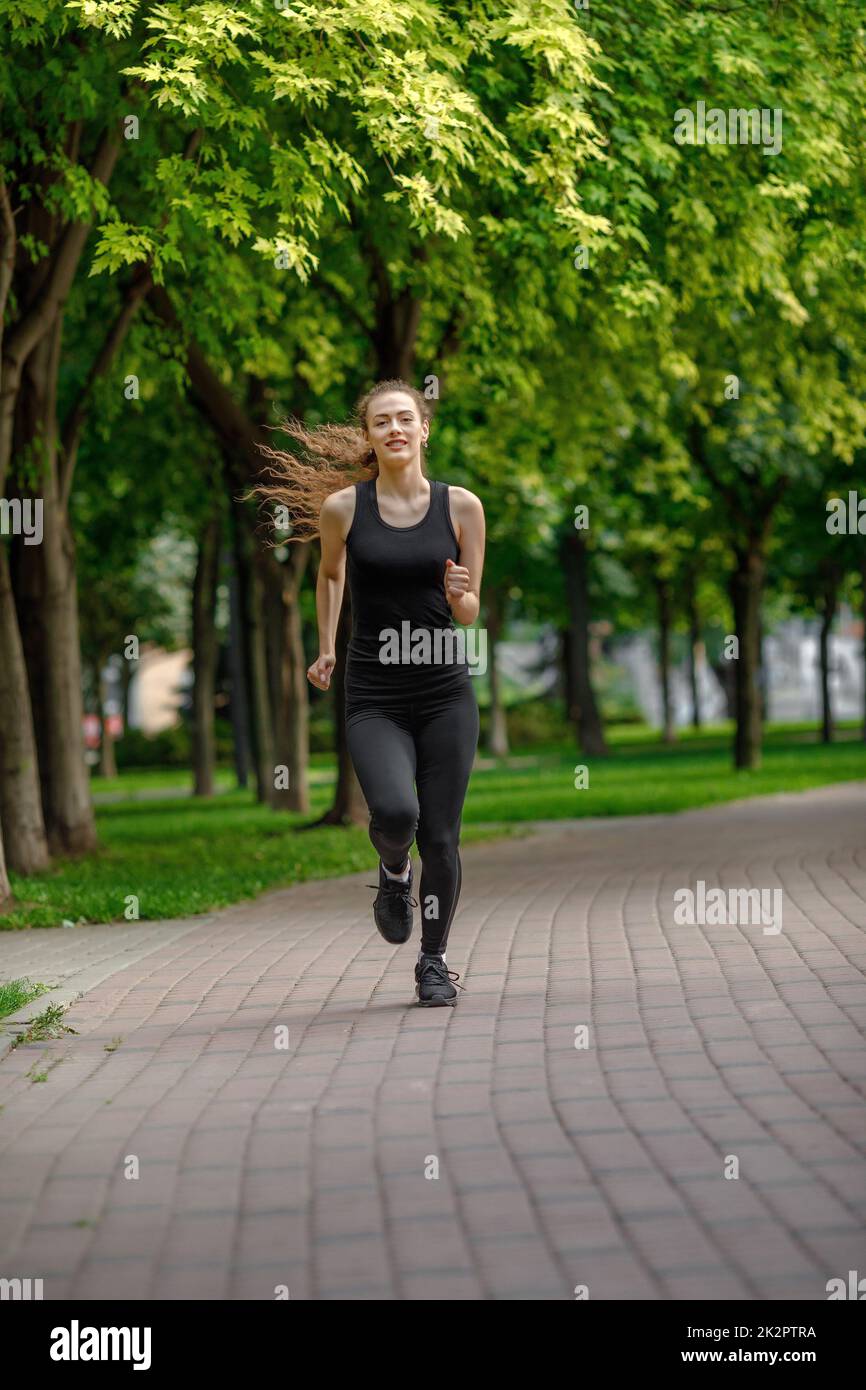 young attractive woman running Stock Photo - Alamy