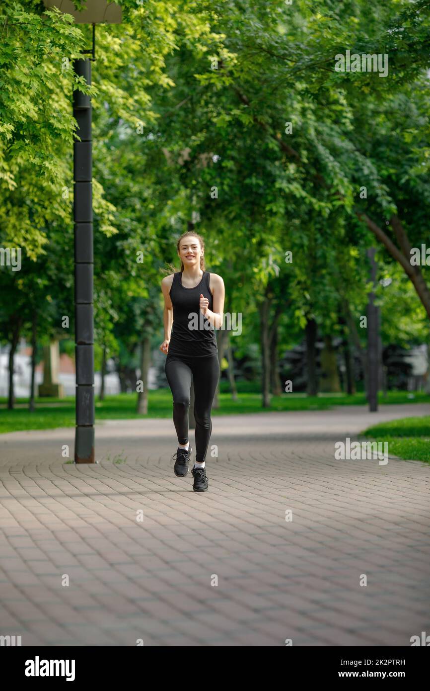 young attractive woman running Stock Photo - Alamy