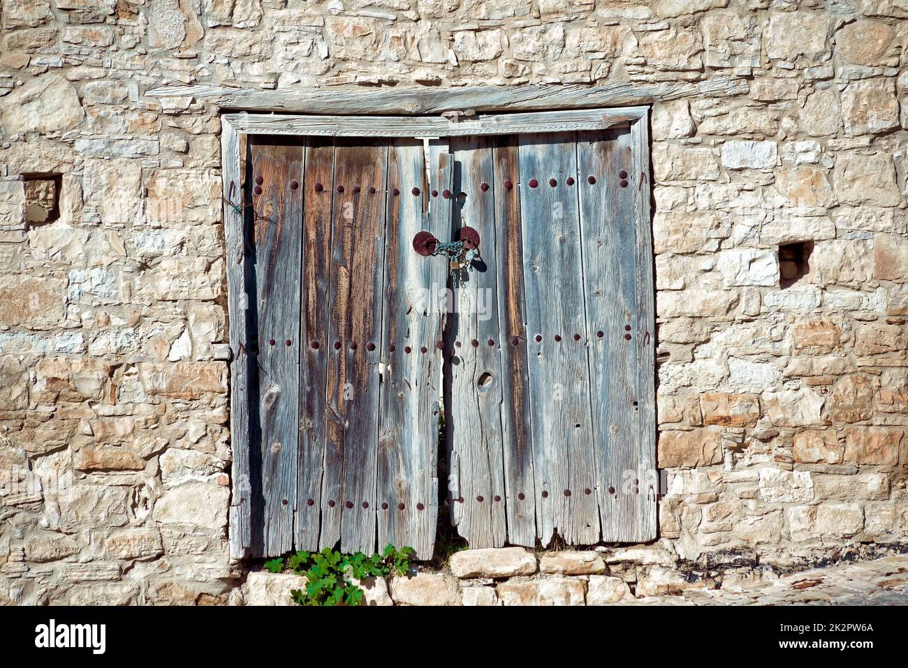 Old weathered door in a stone wall. Cyprus Stock Photo - Alamy
