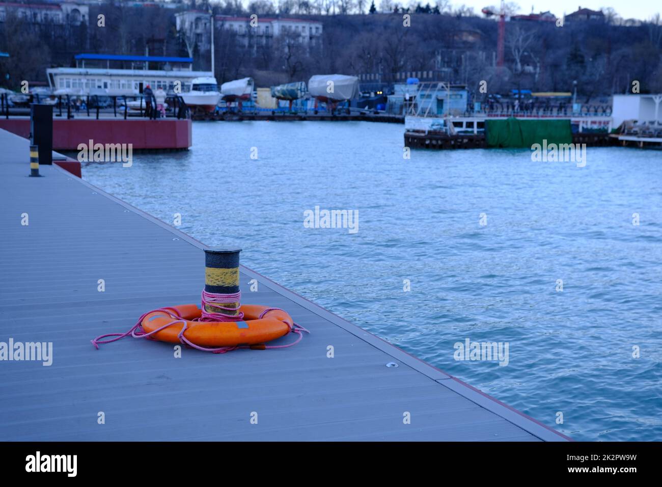 Lifebuoy ring on berth near the bollard with sea view of Marina ...