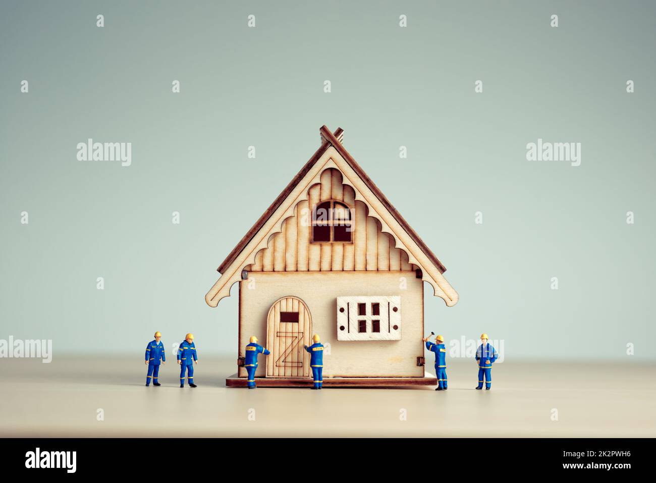 Miniature workers build a new house Stock Photo - Alamy