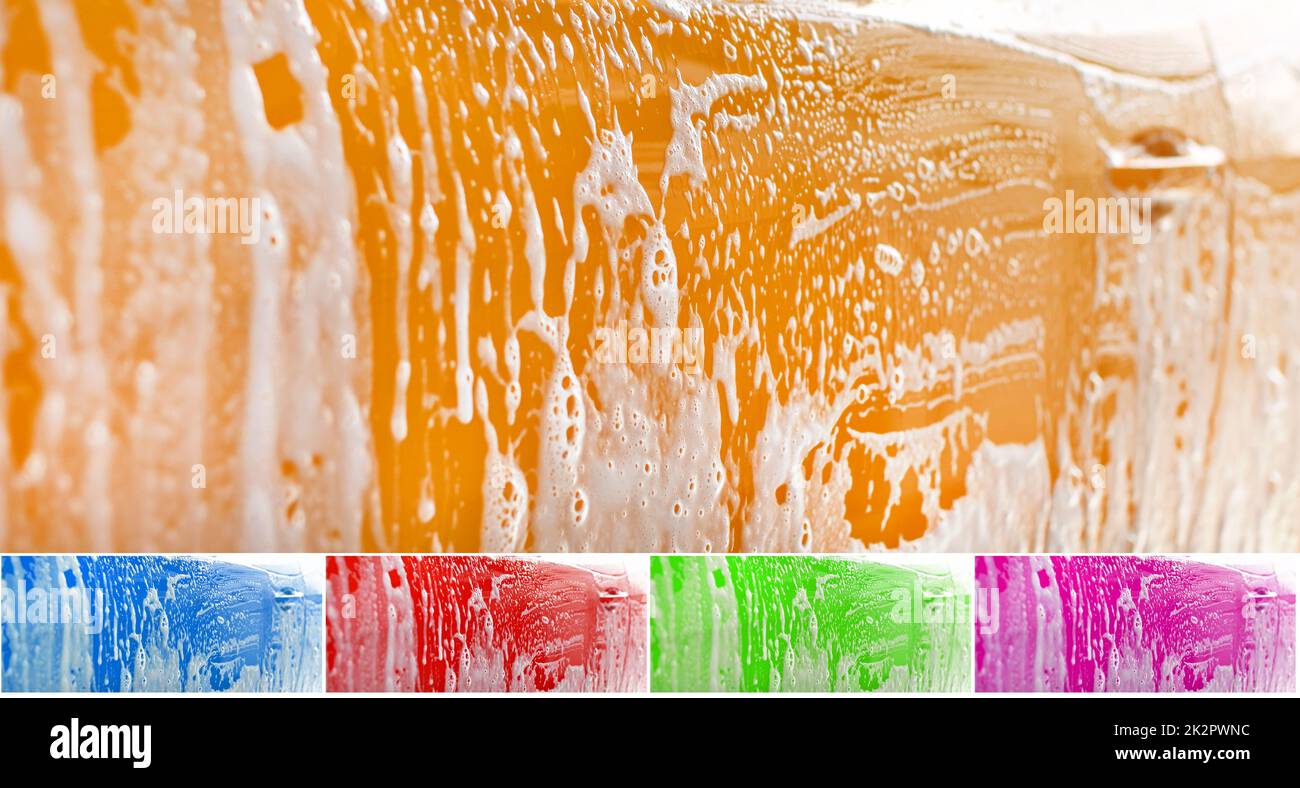 Side of yellow car washed, shampoo and foam on yellow surface. Color ...