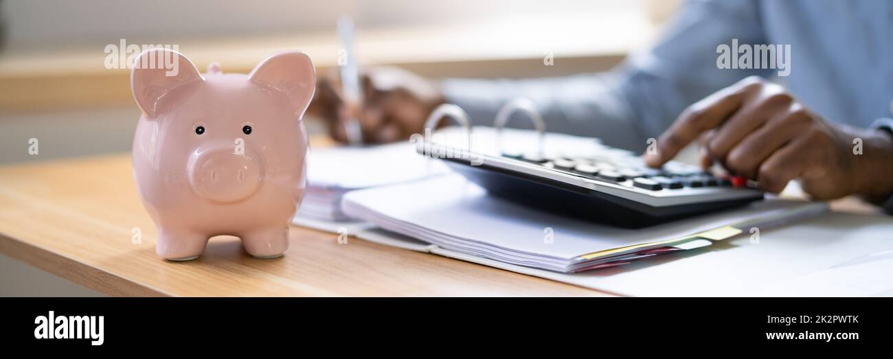 African Accounting Tax Advisor Using Calculator Stock Photo - Alamy