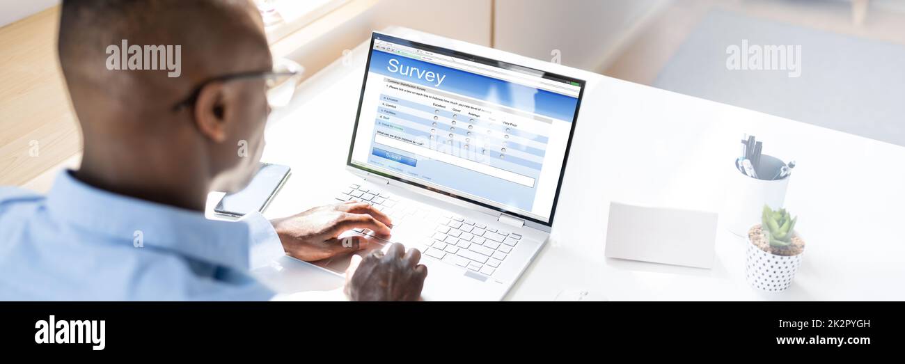 African Man Filling Online Survey Form Stock Photo - Alamy