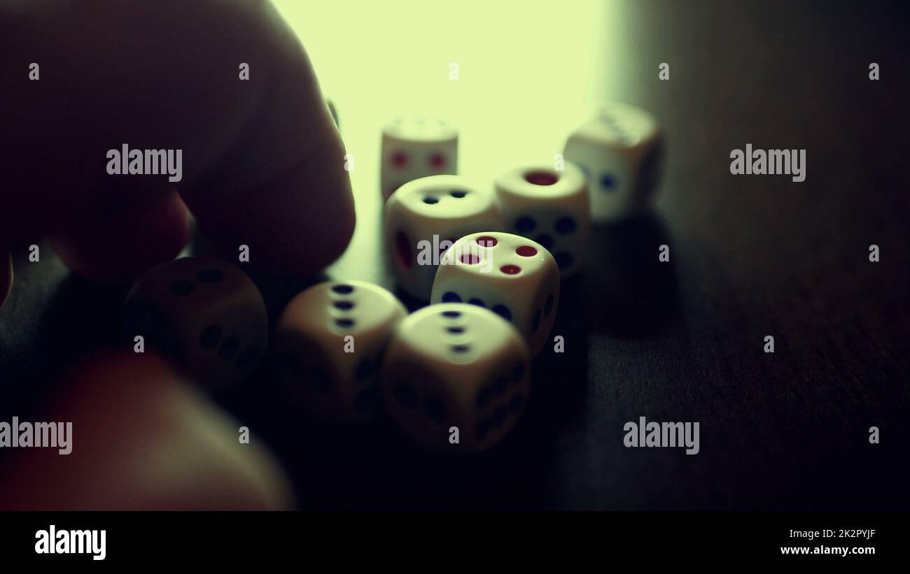 Finger tapping on table with dice on shallow depth of field Stock Photo ...