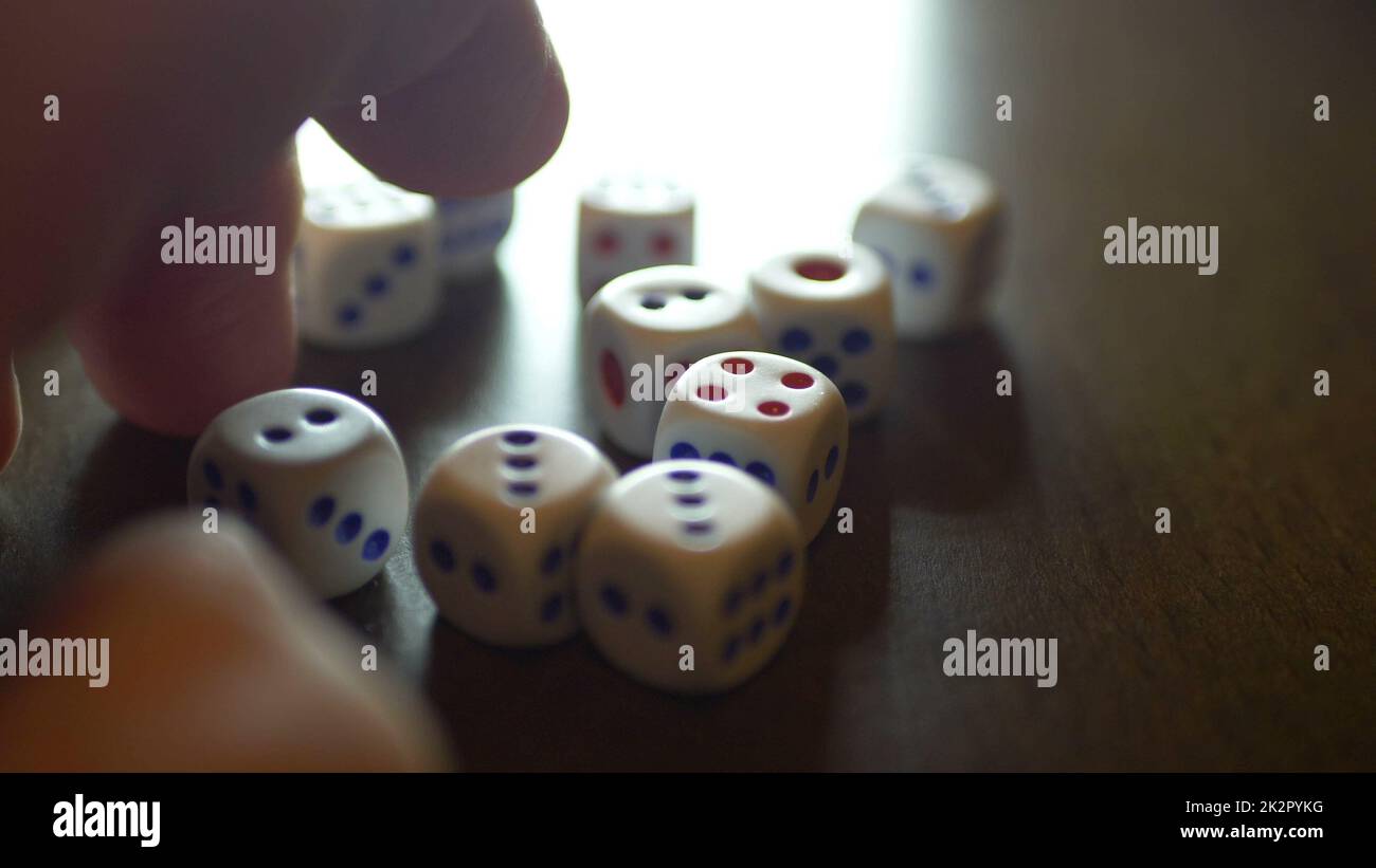 Finger tapping on table with dice on shallow depth of field Stock Photo ...