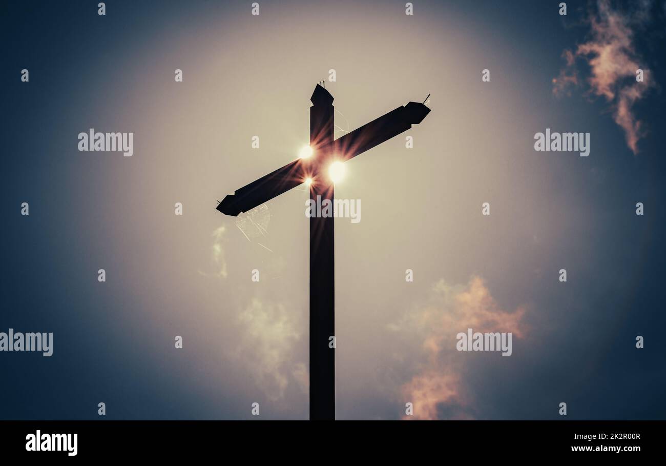 Wooden cross with sun and sky in background Stock Photo - Alamy