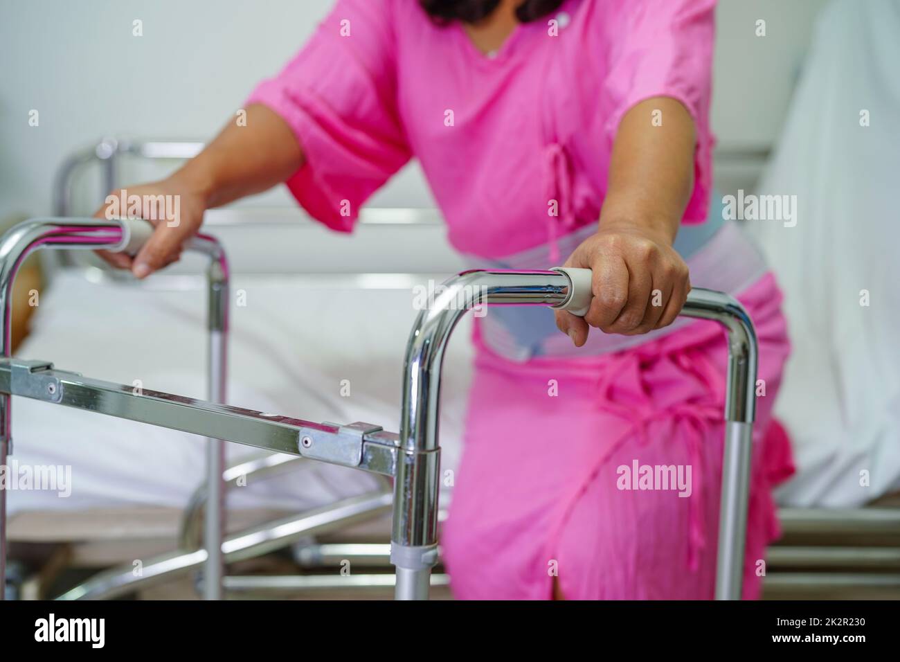 Asian middle-aged lady woman patient walk with walker at nursing ...