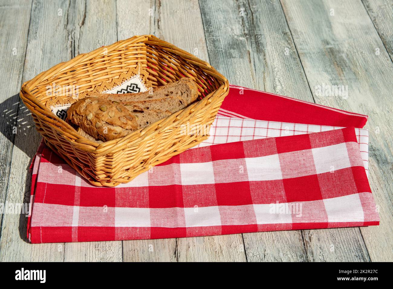 Closeup of slices of fresh baked whole grain bread in a wicker basket ...