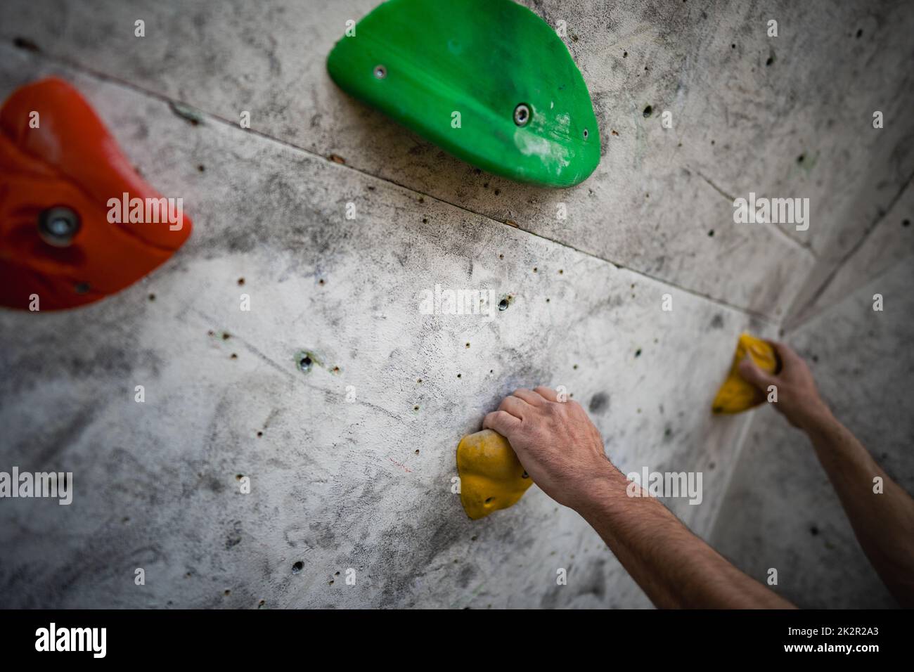 Male hand smeared with magnesium powder grabbing a hold of a climbing ...