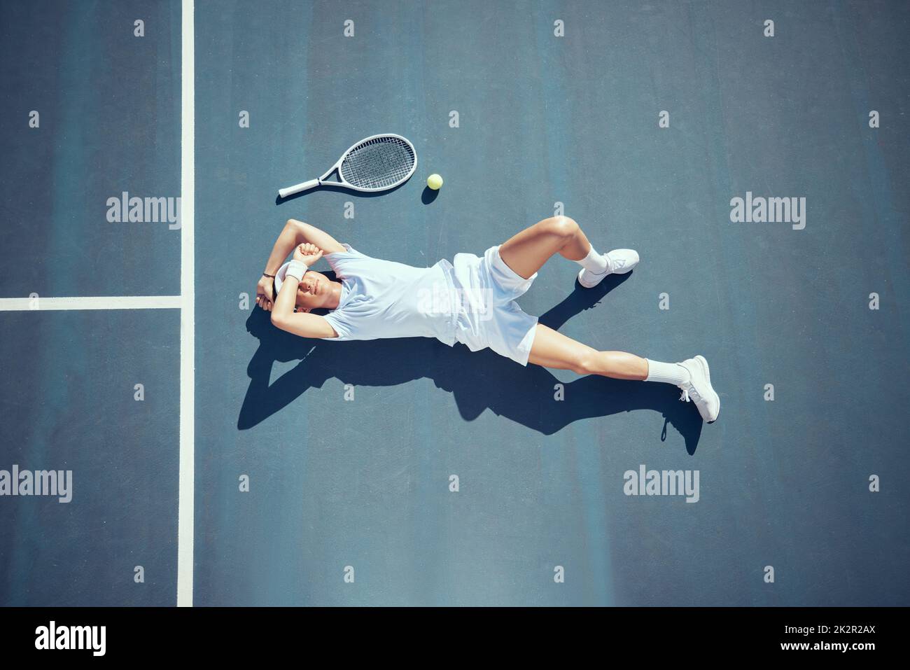 Tired tennis sports loser man on floor with racket, ball and court in ...