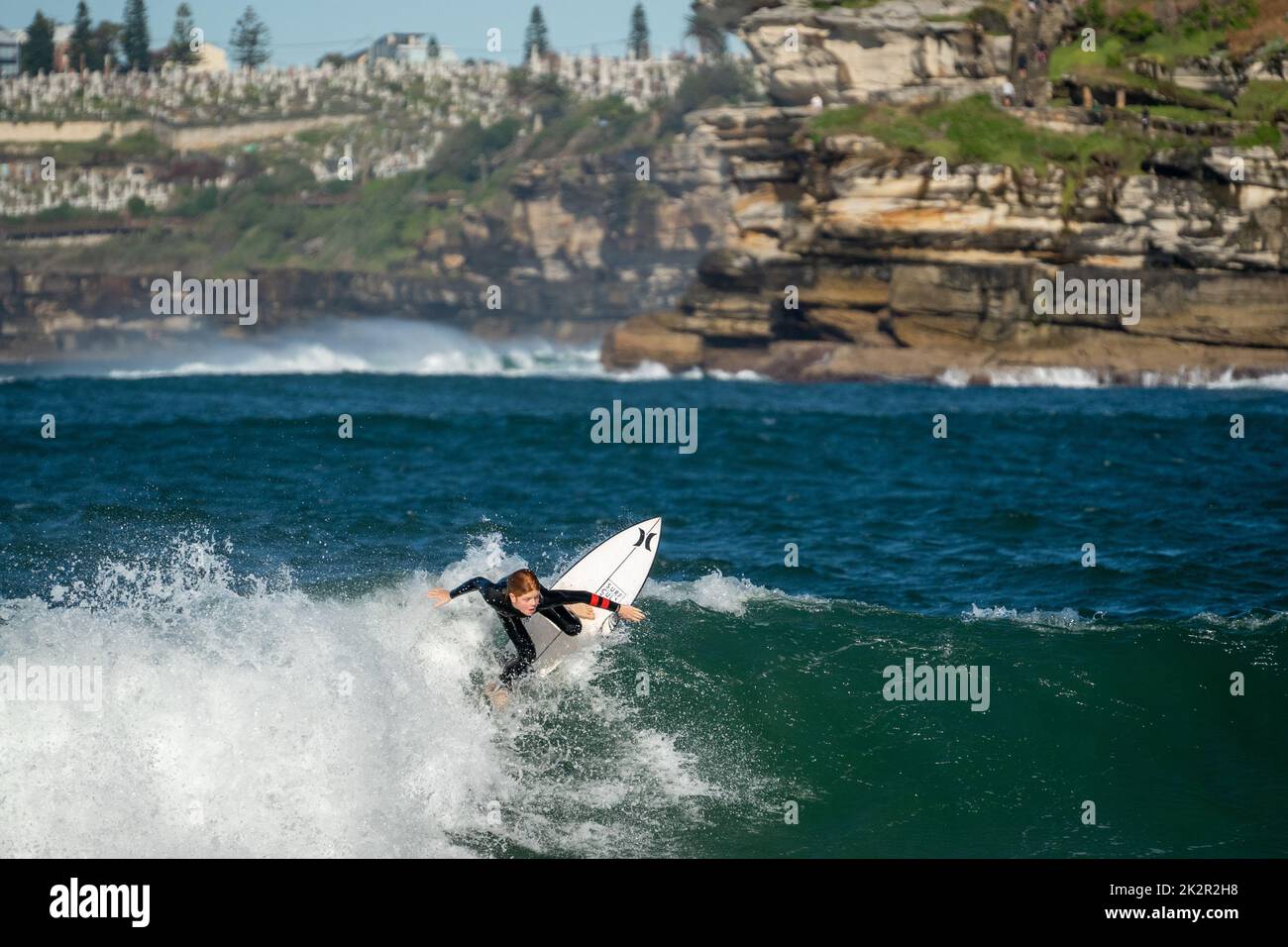 A surfer standing on the shortboard and catching waves, and almost ...