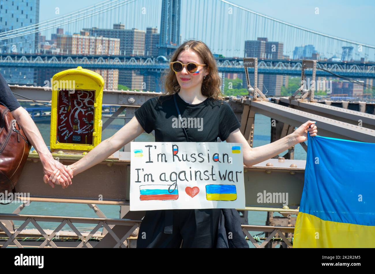 Female participant of the Human Chain with I am Russian, I am against ...