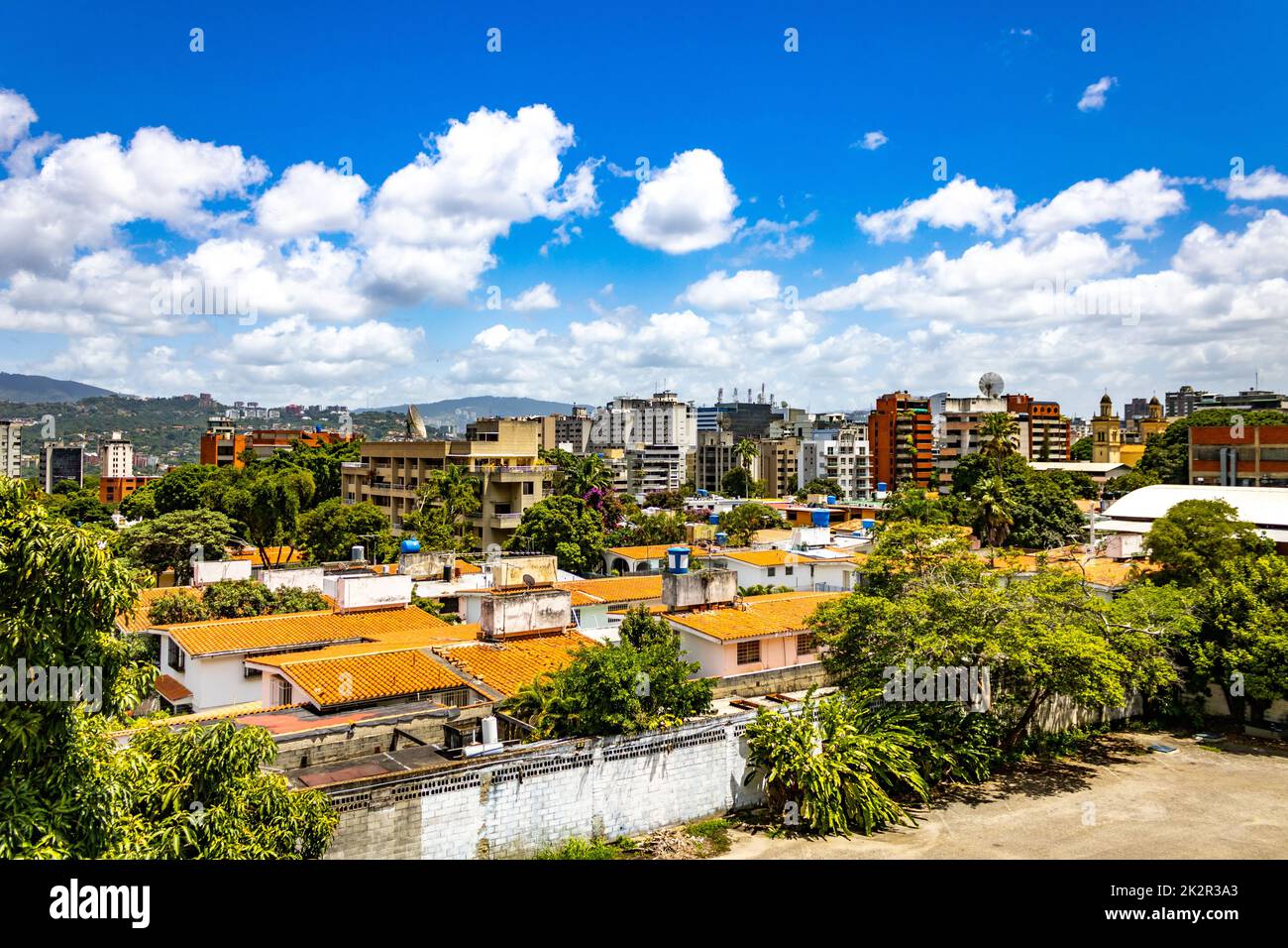 The colorful city buildings of Caracas under the blue sky with clouds ...