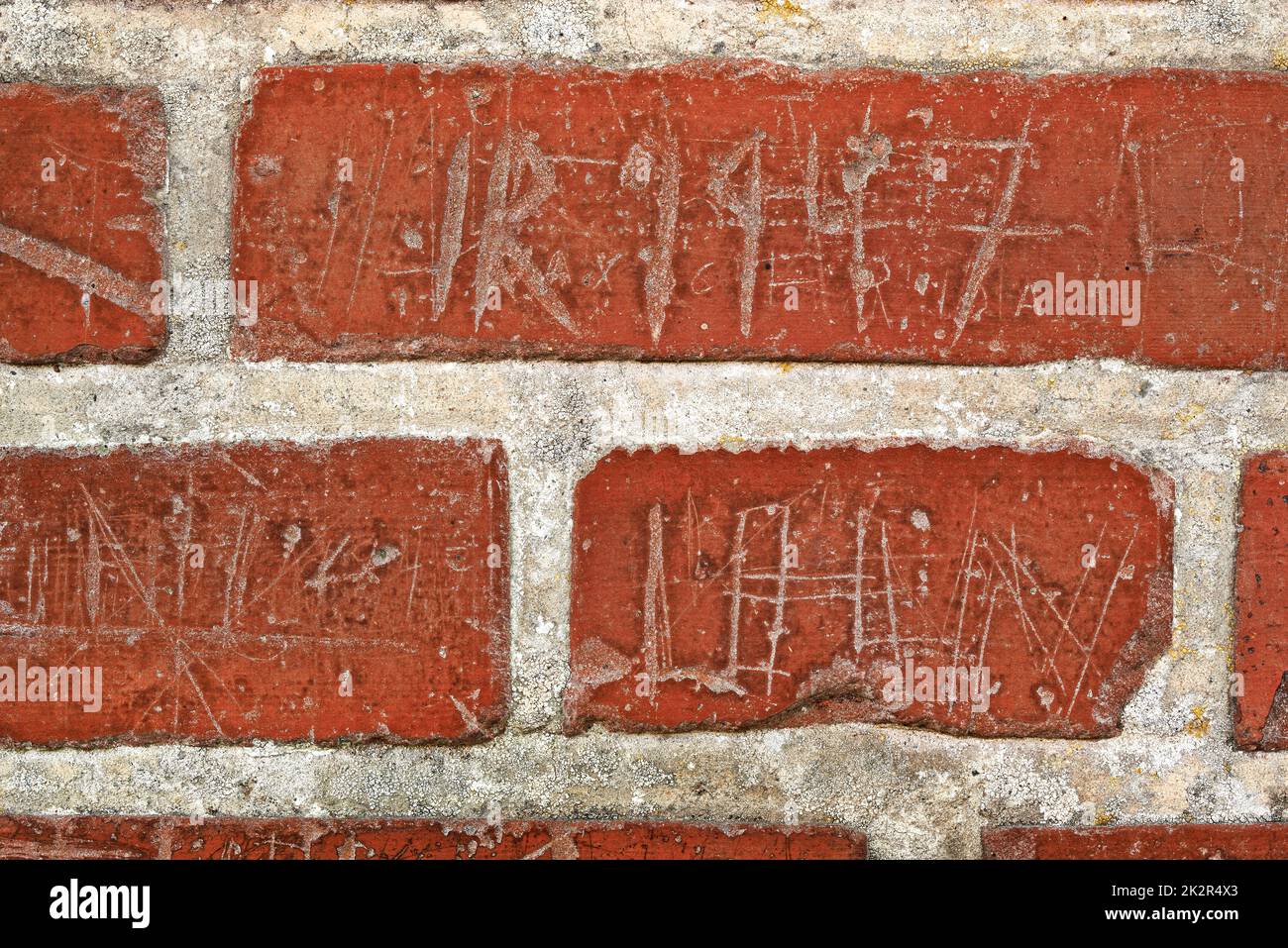 Signature wall. A photo of brick wall of an old school with a lot of ...