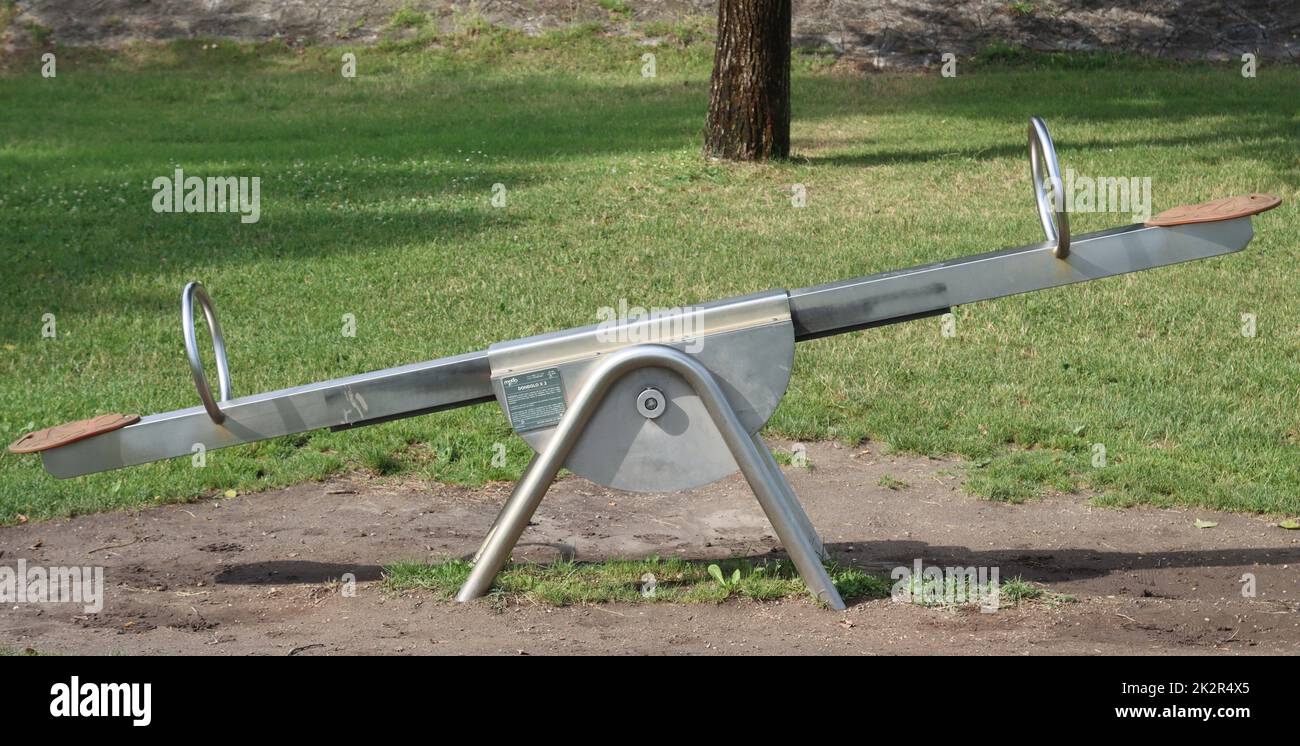 A steel rocking swing in a park Stock Photo - Alamy