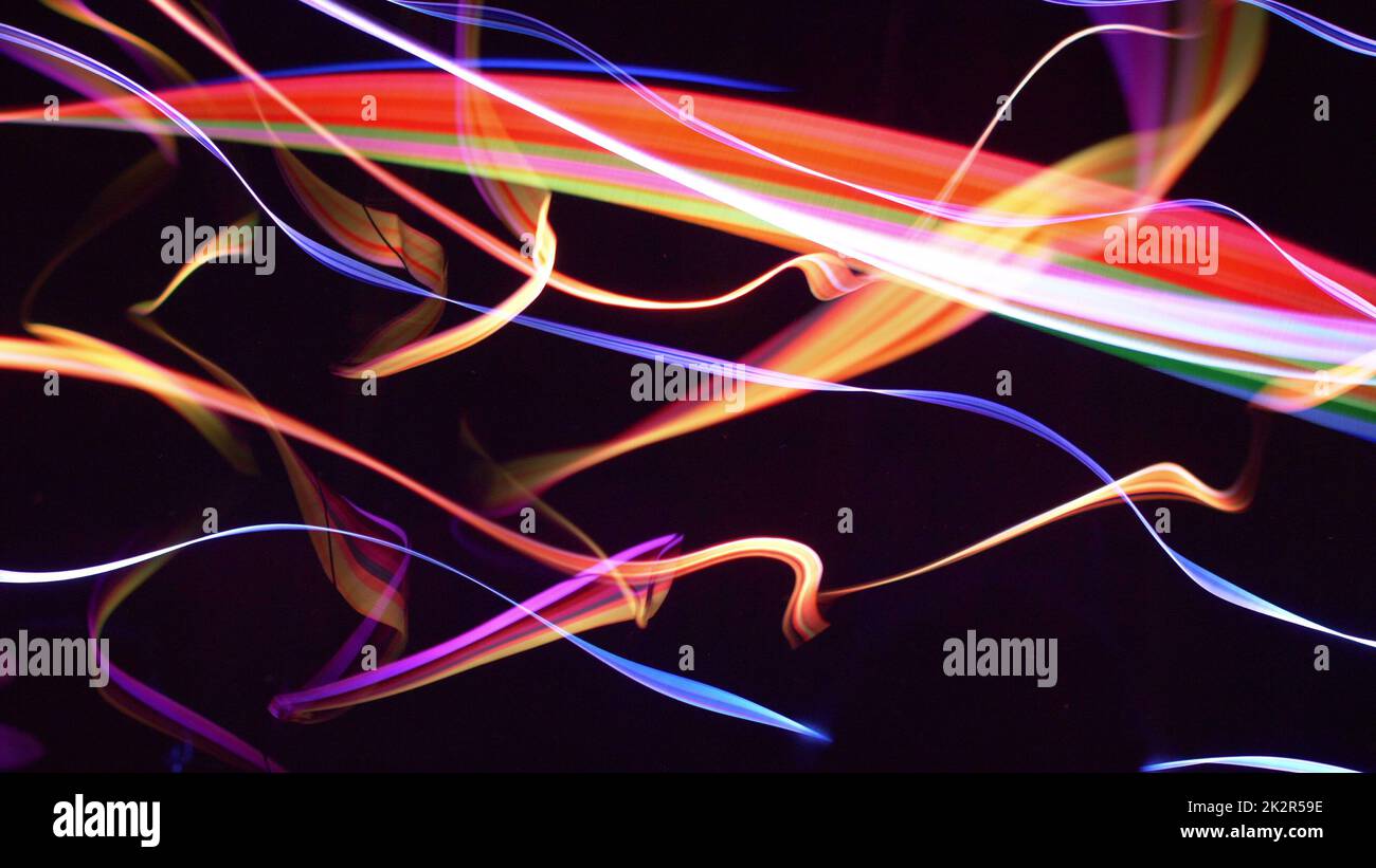 Colorful fiber strings in motion against black background Stock Photo ...