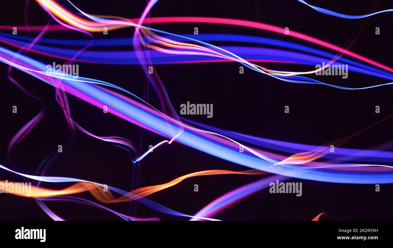 Colorful fiber strings in motion against black background Stock Photo ...