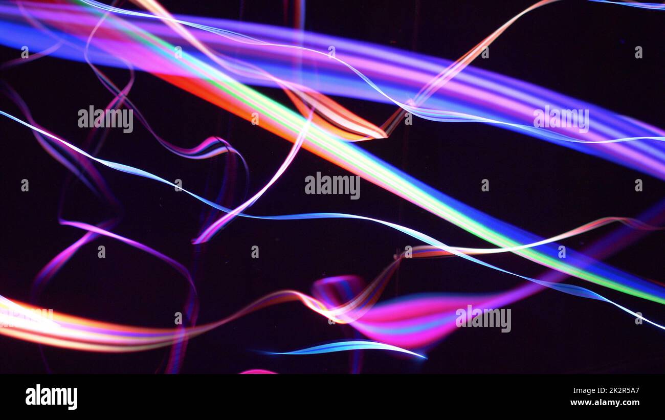 Colorful fiber strings in motion against black background Stock Photo ...