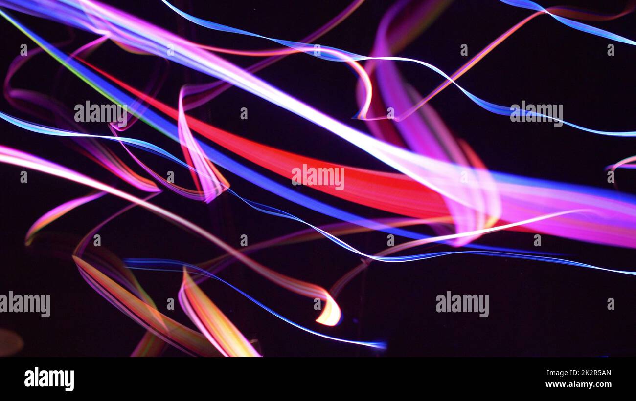 Colorful fiber strings in motion against black background Stock Photo ...