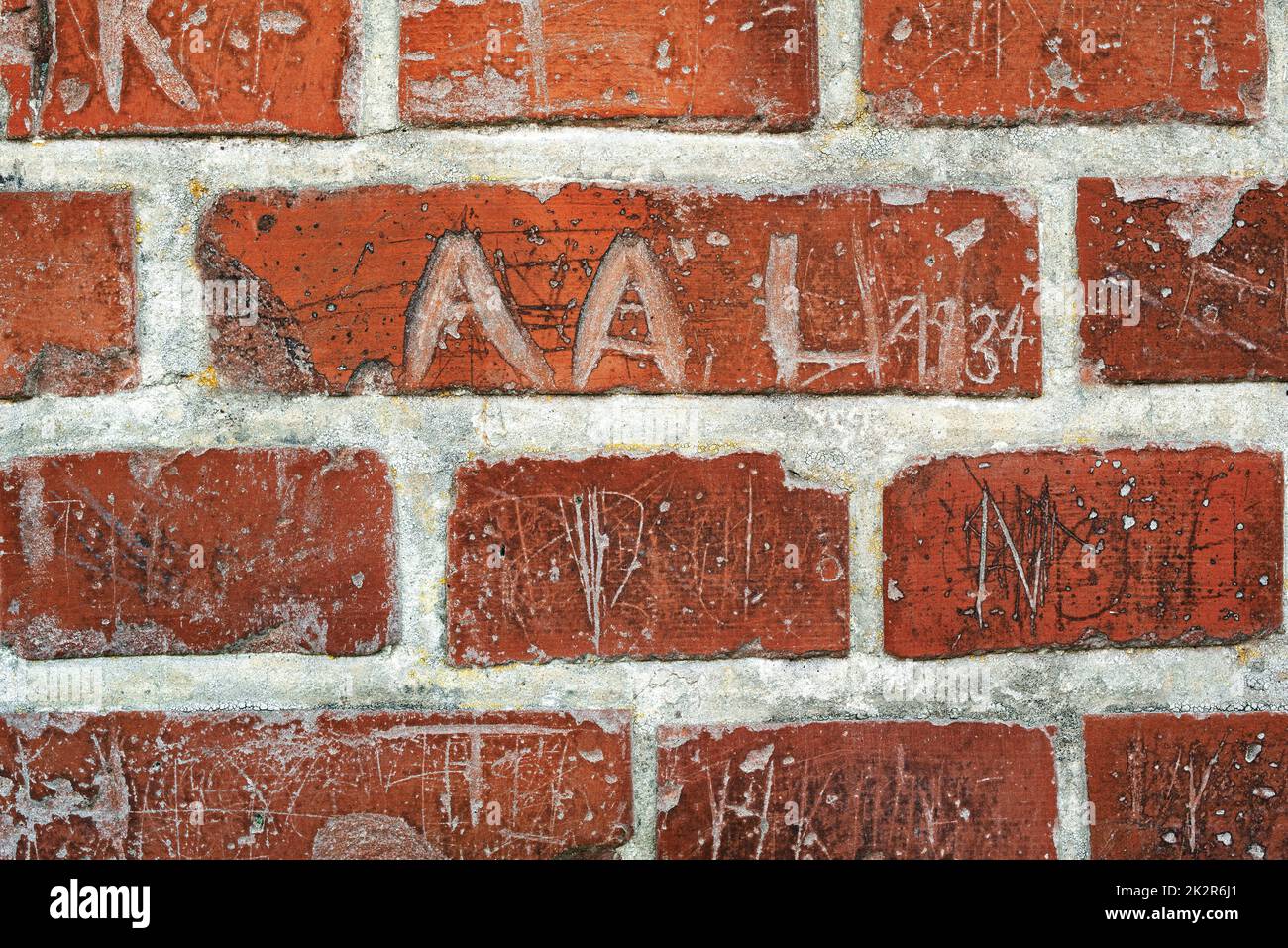 Signature wall. A photo of brick wall of an old school with a lot of ...