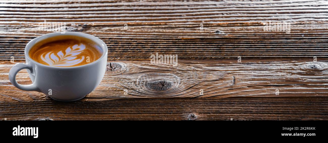 A cup of coffee on an old wooden table Stock Photo - Alamy