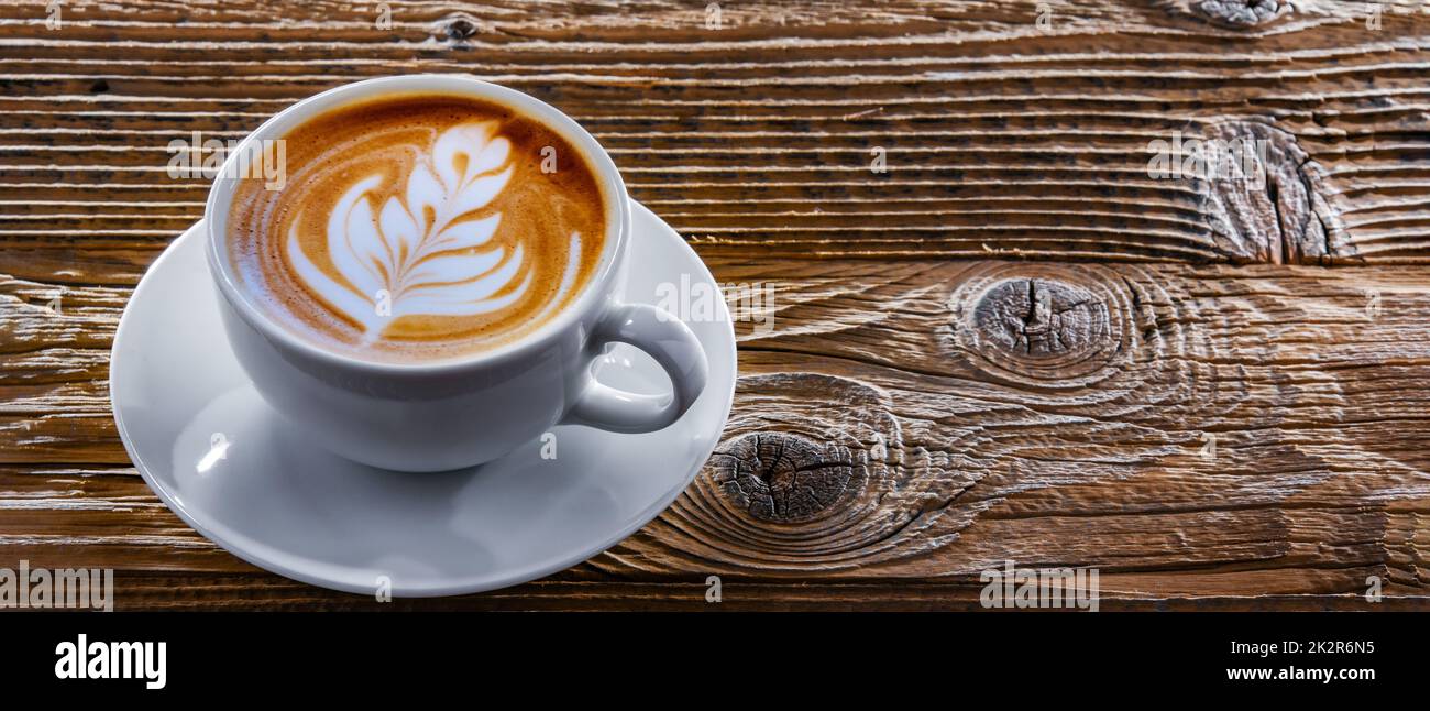 A cup of coffee on an old wooden table Stock Photo - Alamy