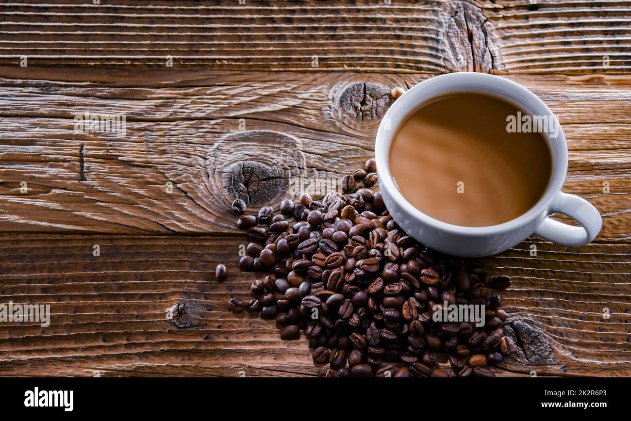 A cup of coffee on an old wooden table Stock Photo - Alamy