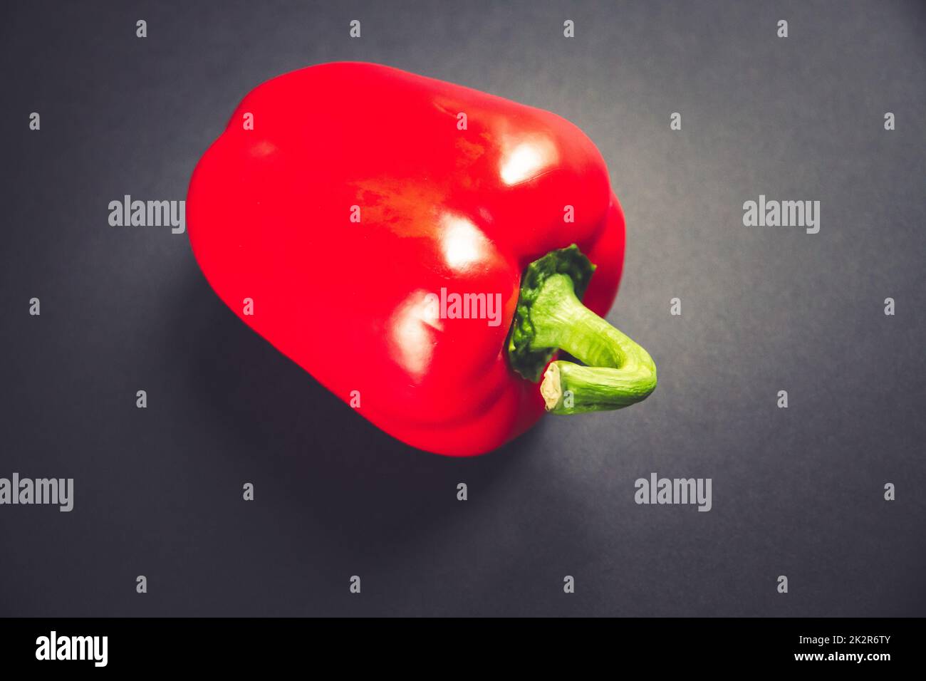 Red bell pepper isolated on black background Stock Photo - Alamy