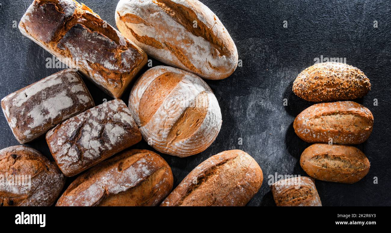 Assorted bakery products including loafs of bread and rolls Stock Photo ...