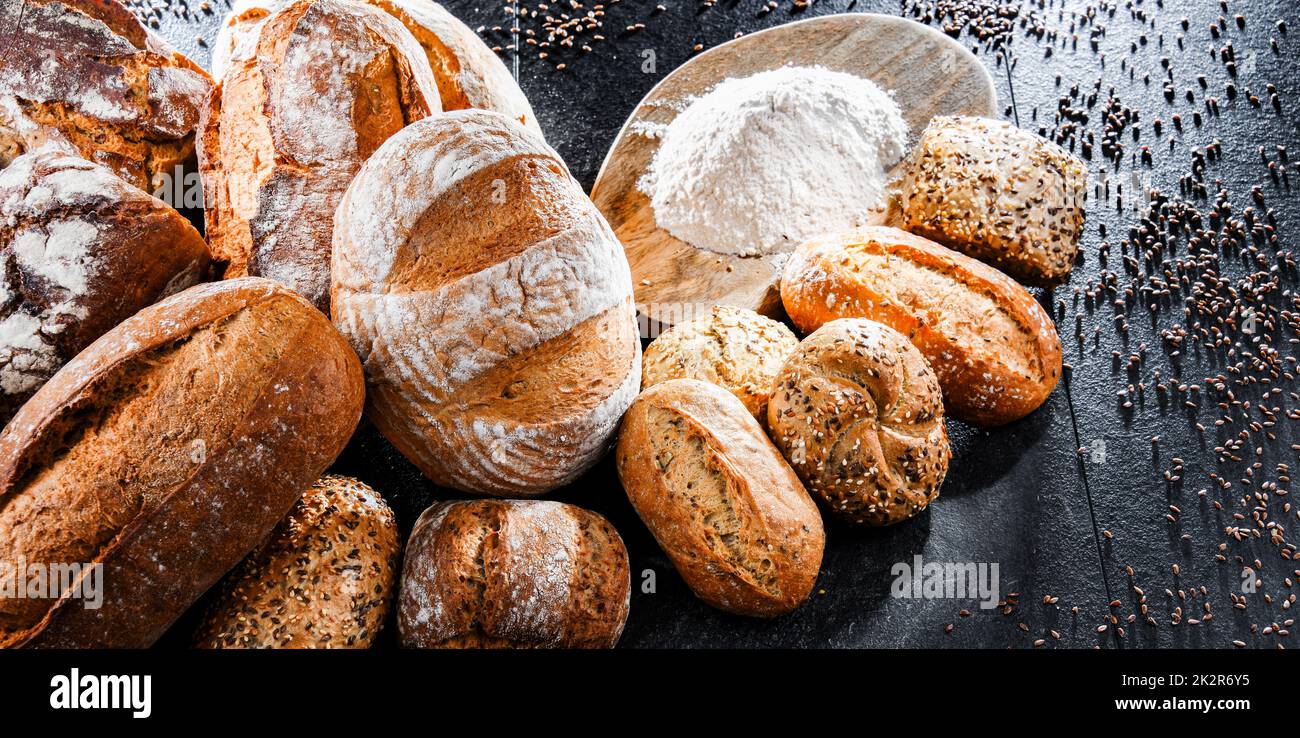 Assorted bakery products including loafs of bread and rolls Stock Photo ...