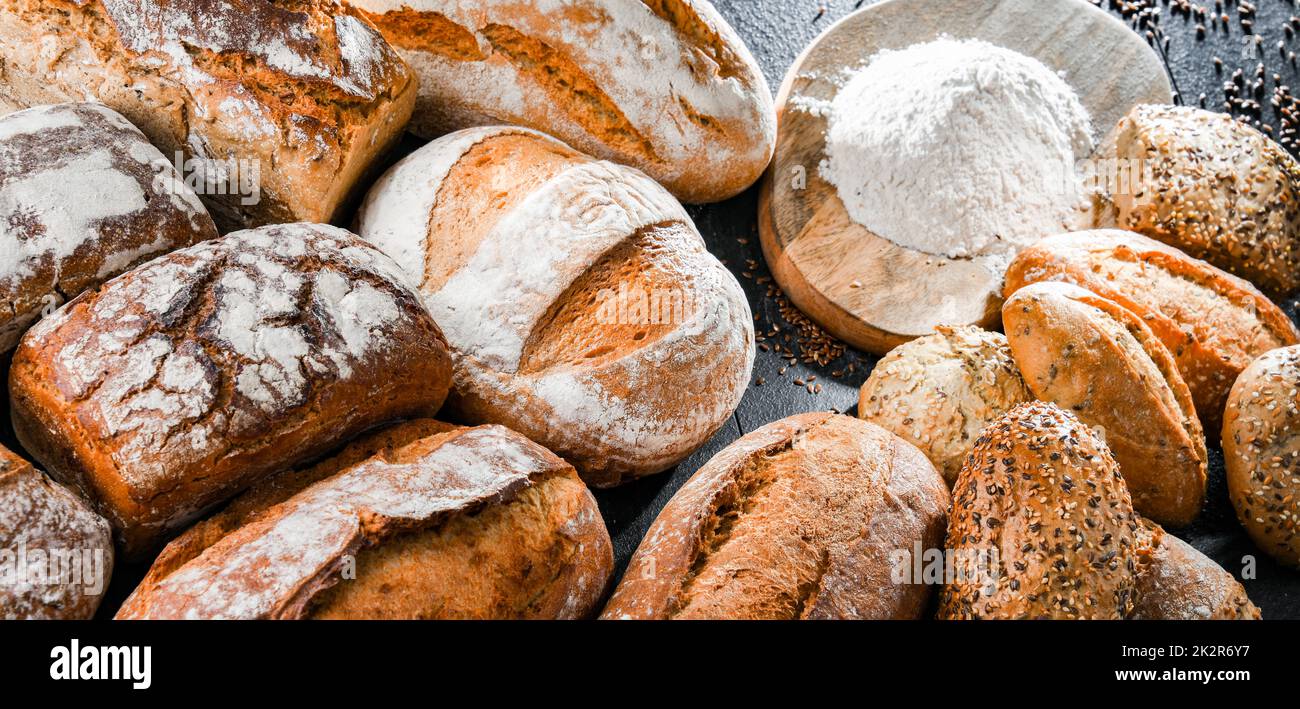 Assorted bakery products including loafs of bread and rolls Stock Photo ...