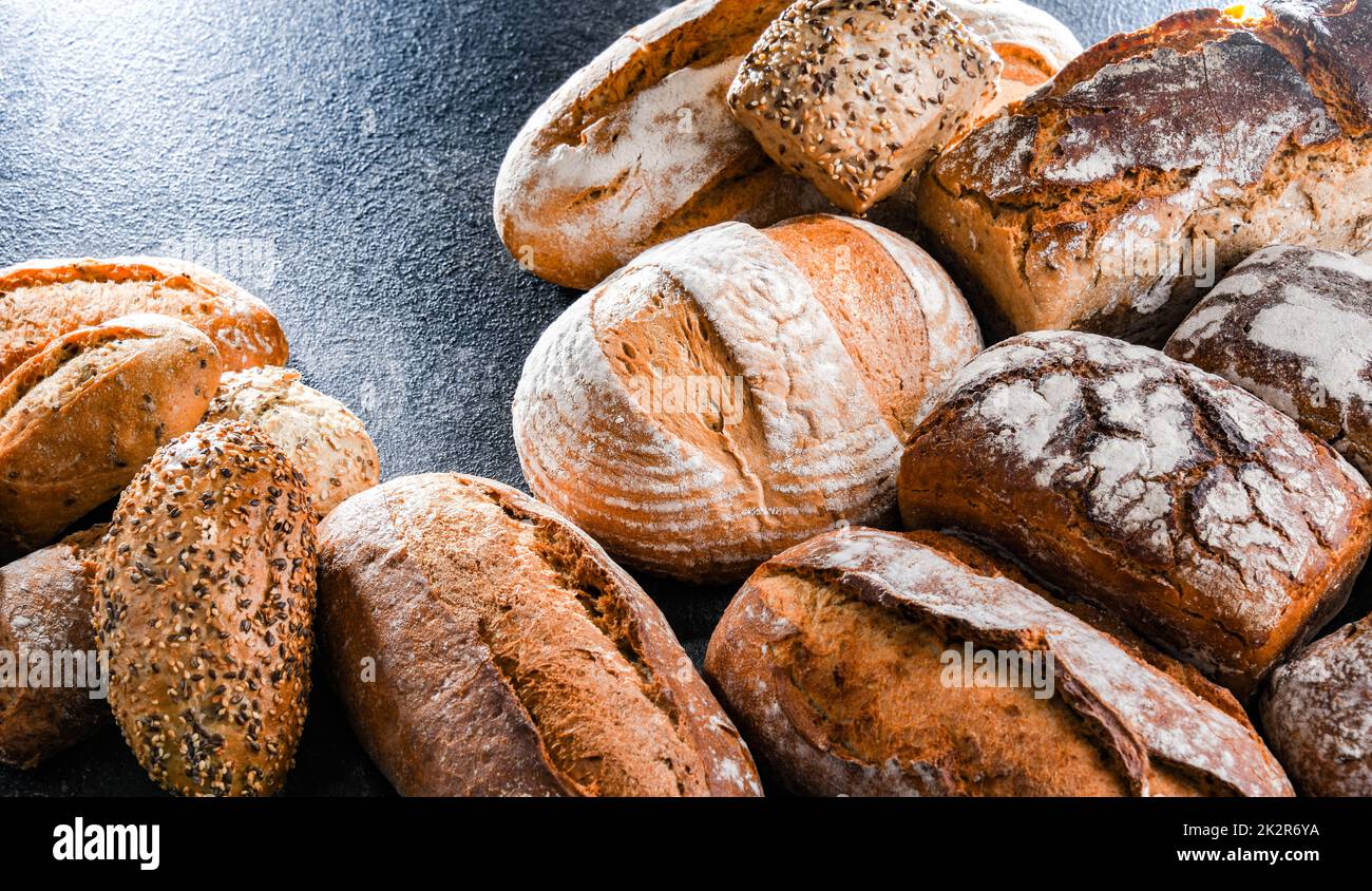 Assorted bakery products including loafs of bread and rolls Stock Photo ...