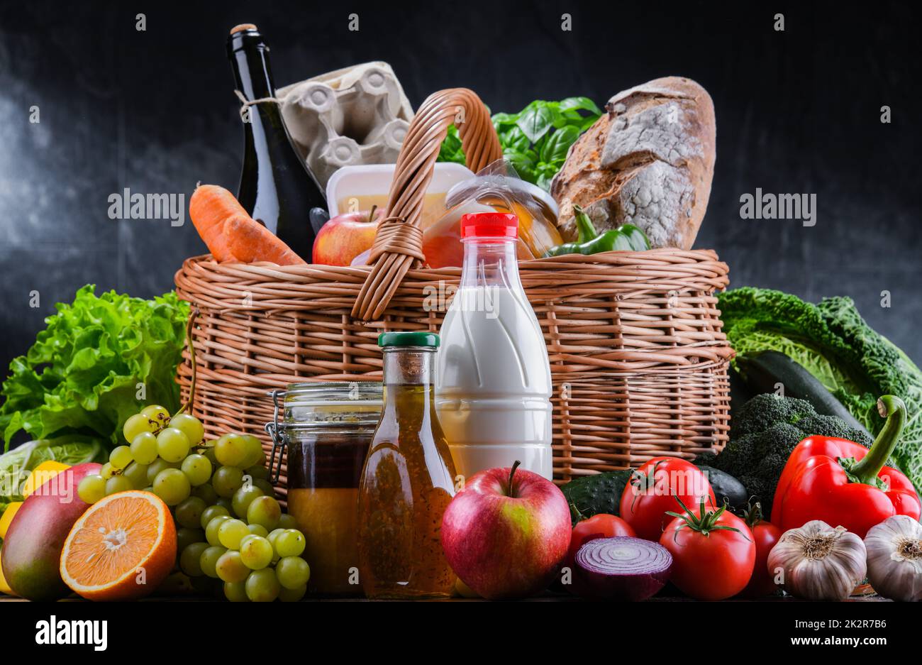 Wicker basket with assorted grocery products Stock Photo - Alamy