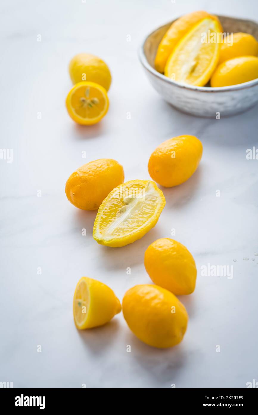 Small citrus fruits limequat with bowl on table Stock Photo - Alamy
